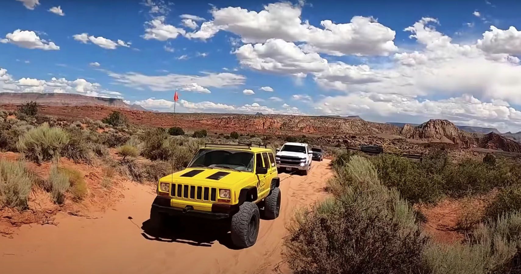Watch This Jeep Cherokee Tow Seven Amateurs Out Of A Sand Trap
