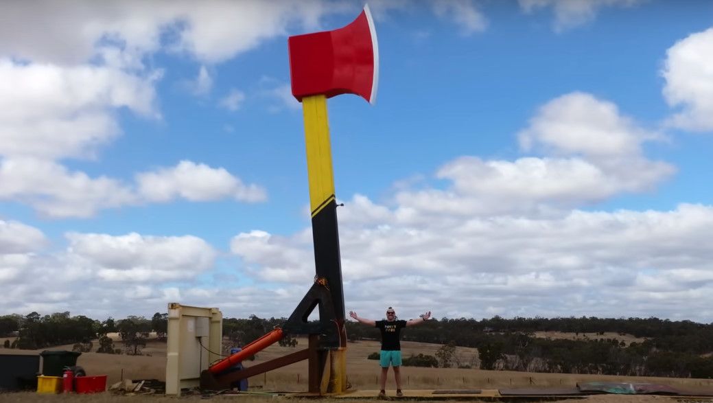 Watch This Giant Axe Split Not-A-Tesla In Half In A Very Aussie Experiment
